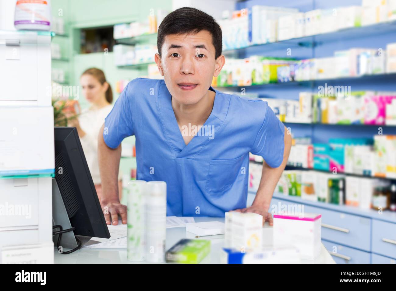 japanese specialist standing near table with cashbox in pharmacy Stock ...
