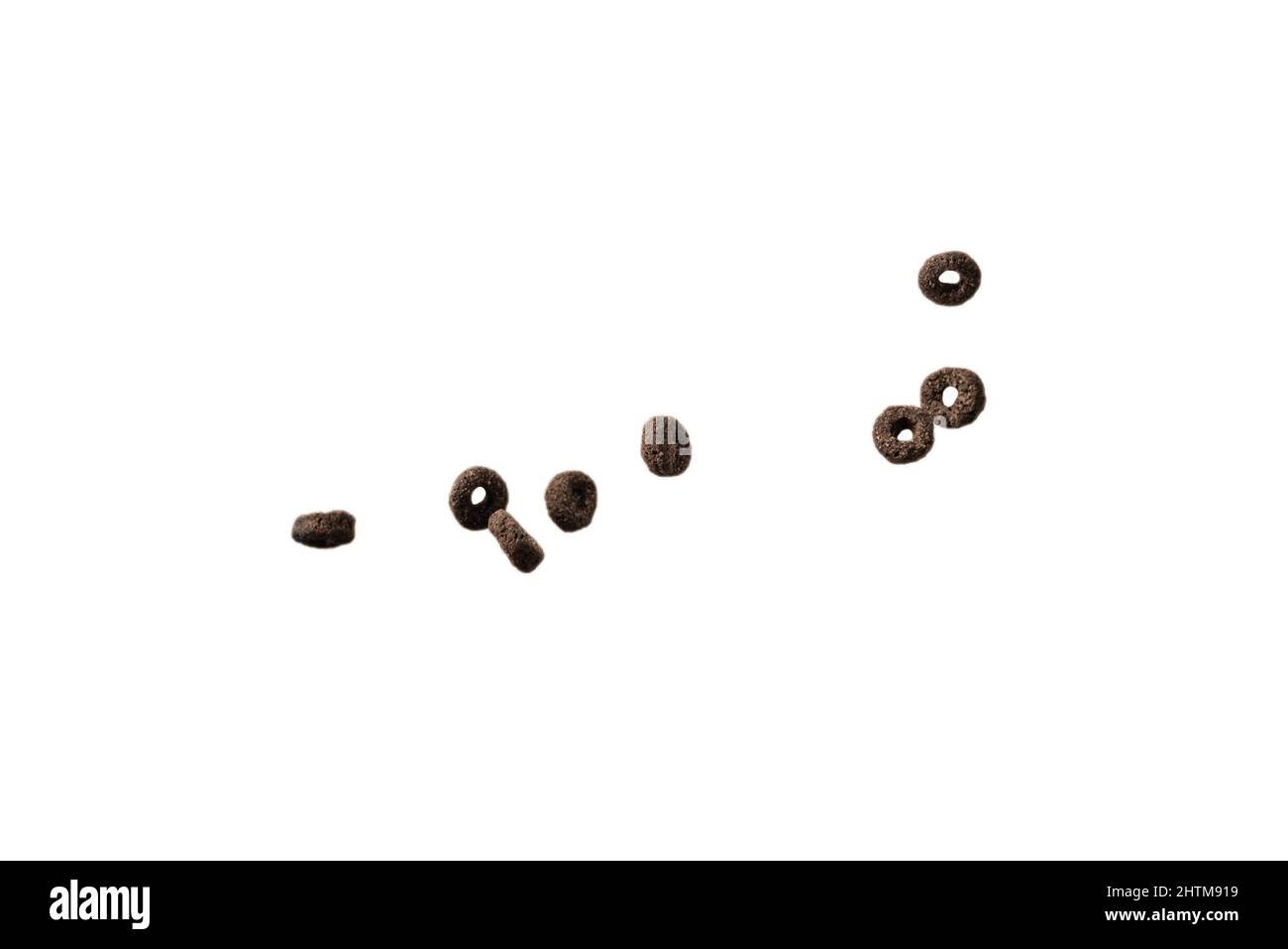 Chocolate rings cereal spill out into a bowl. Breakfast. Isolated on a ...