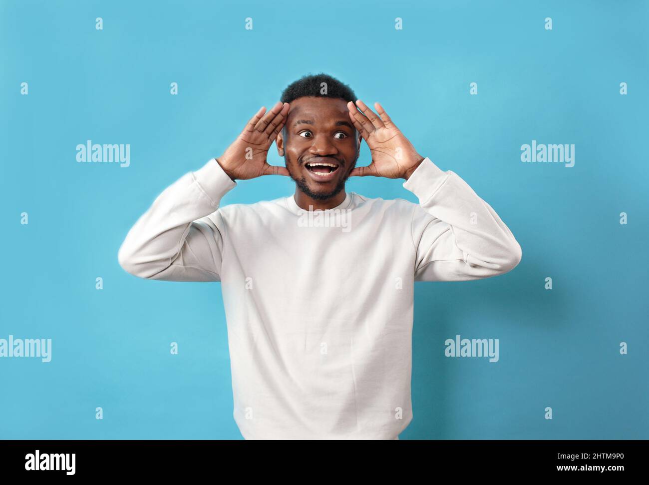 black student student in a white T-shirt looking at the camera with a ...