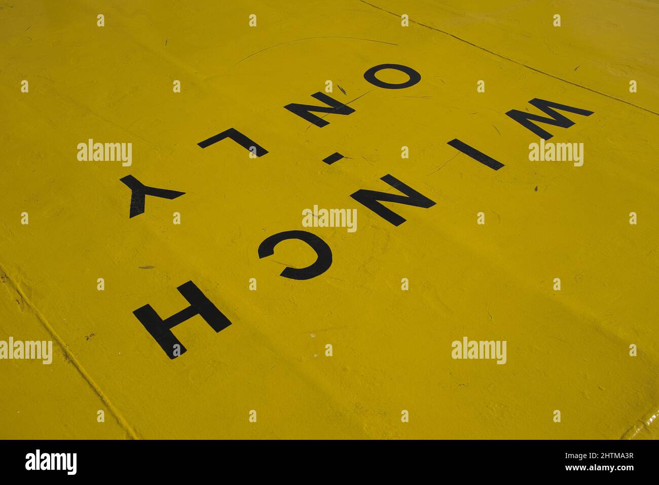 Closeup of a "Winch Only" text on the yellow background Stock Photo - Alamy