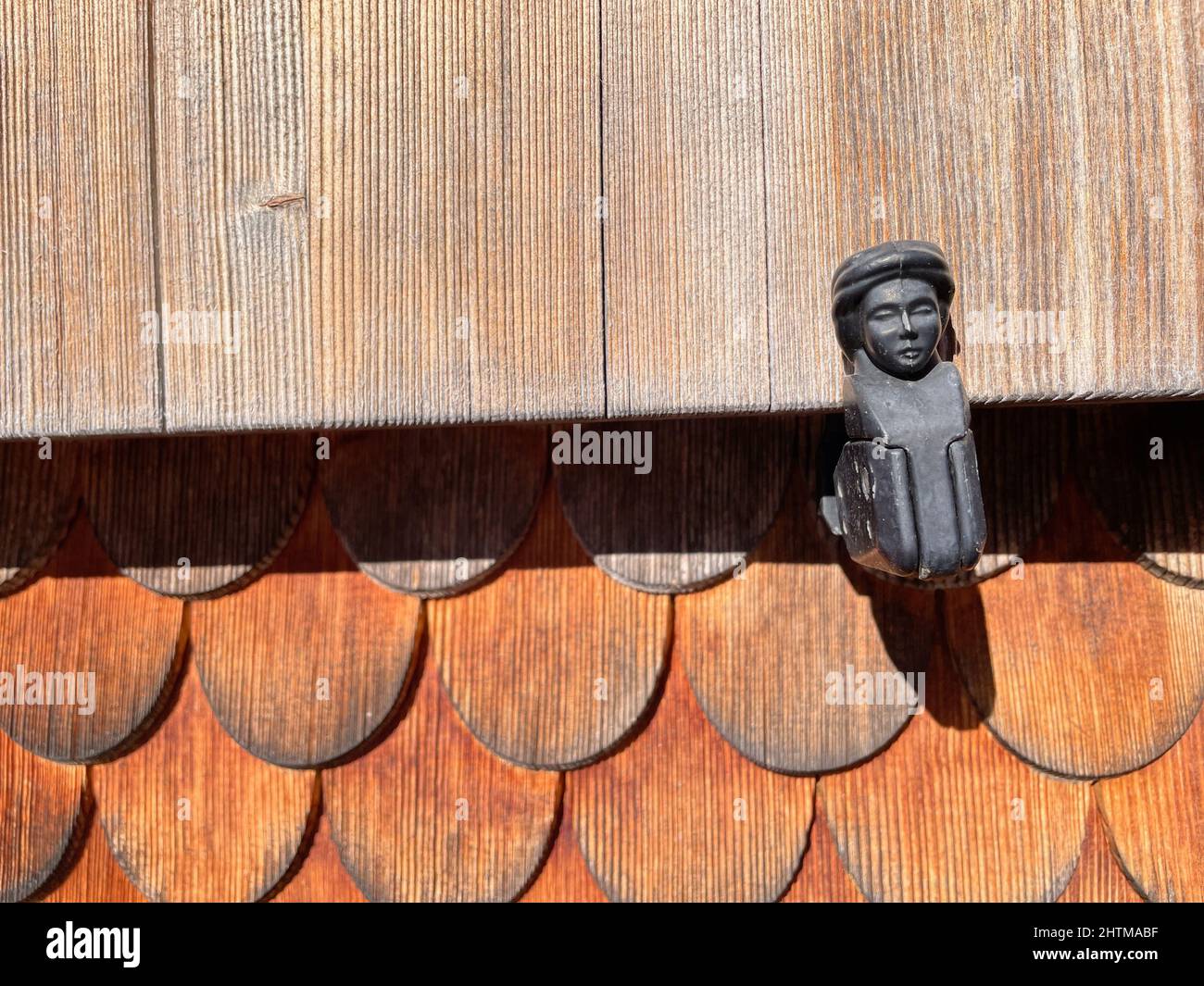 Close up of antique metal window shutter holder in the form of a woman ...