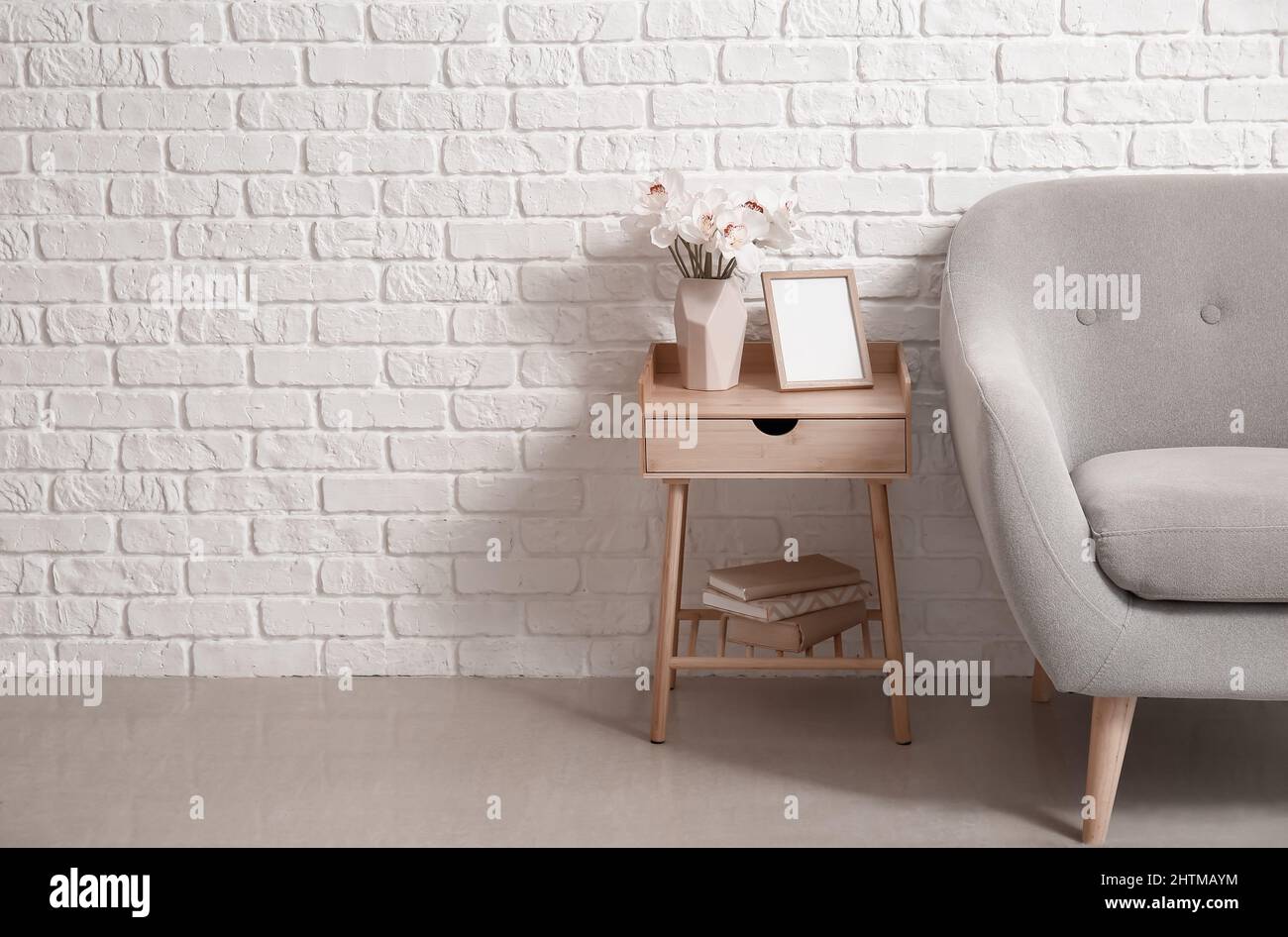 Modern interior of room with table and armchair Stock Photo - Alamy
