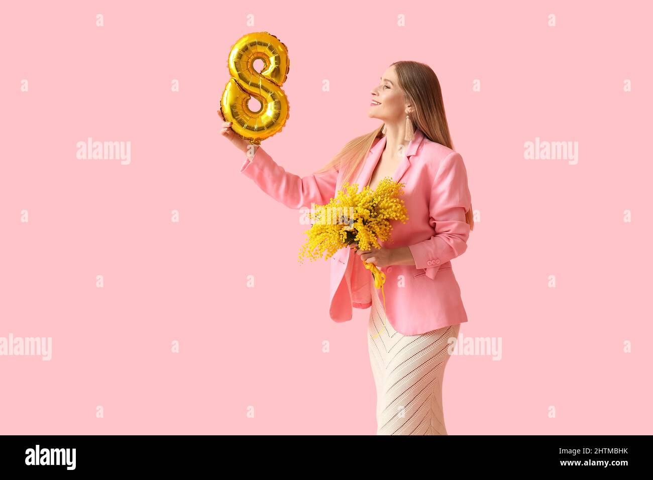 Beautiful woman with balloon in shape of figure 8 and mimosa flowers on ...