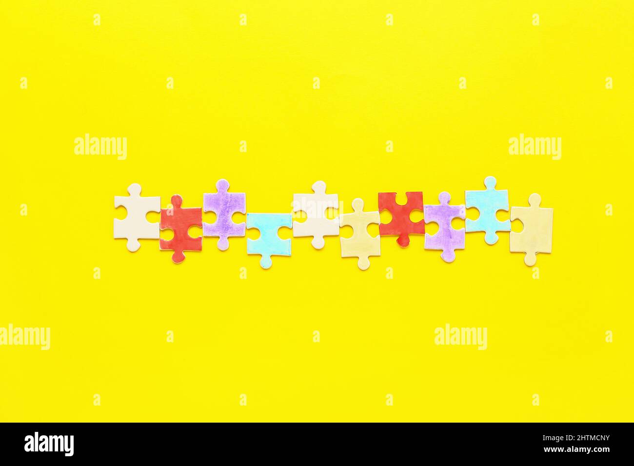 Puzzle pieces on yellow background. Concept of autistic disorder Stock ...