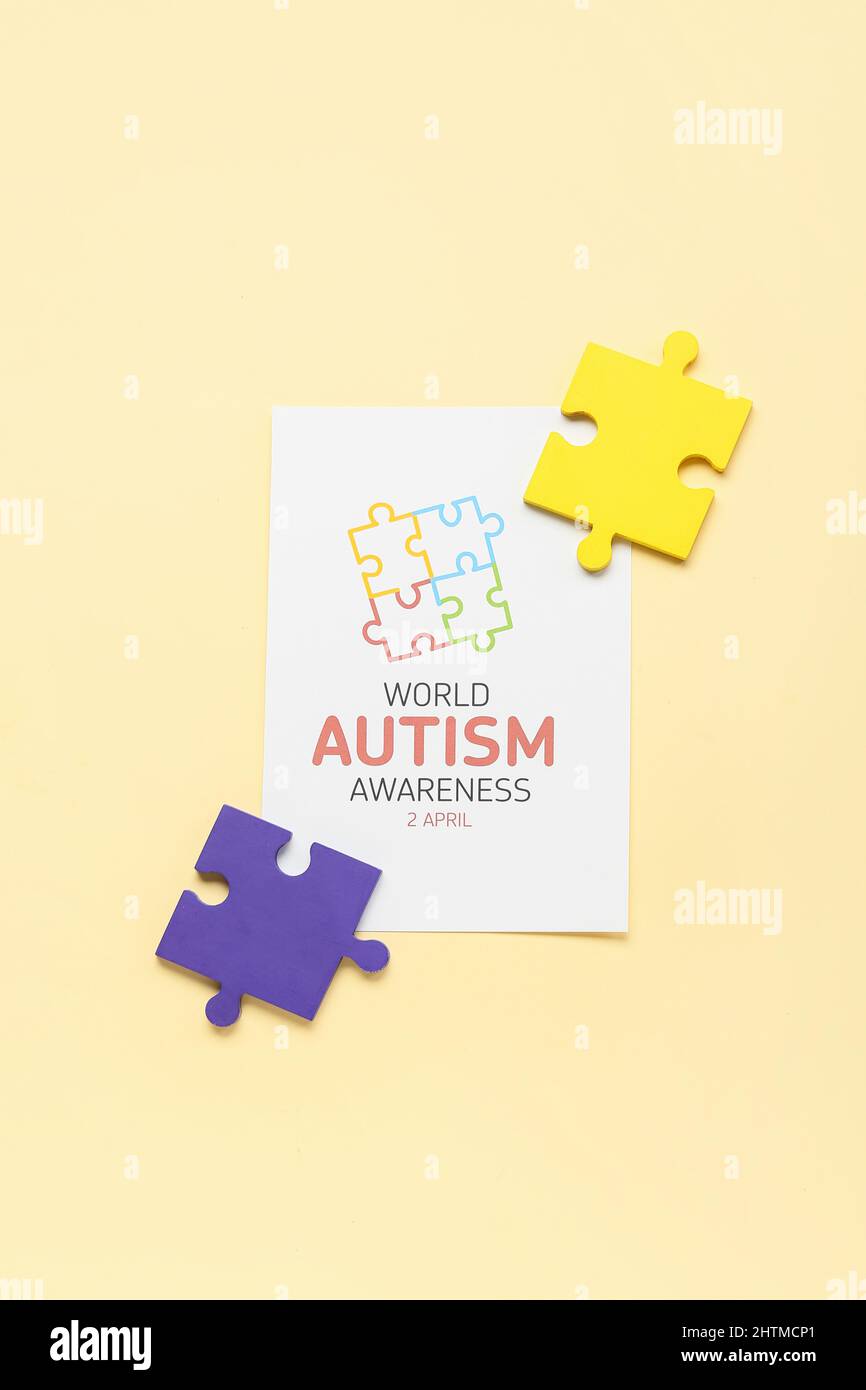 Paper sheet with text WORLD AUTISM AWARENESS 2 APRIL and puzzle pieces ...
