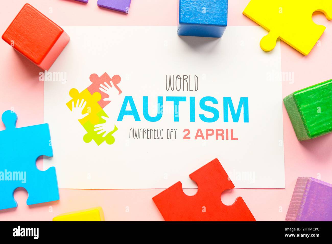 Paper sheet with text WORLD AUTISM AWARENESS DAY 2 APRIL, puzzle pieces ...