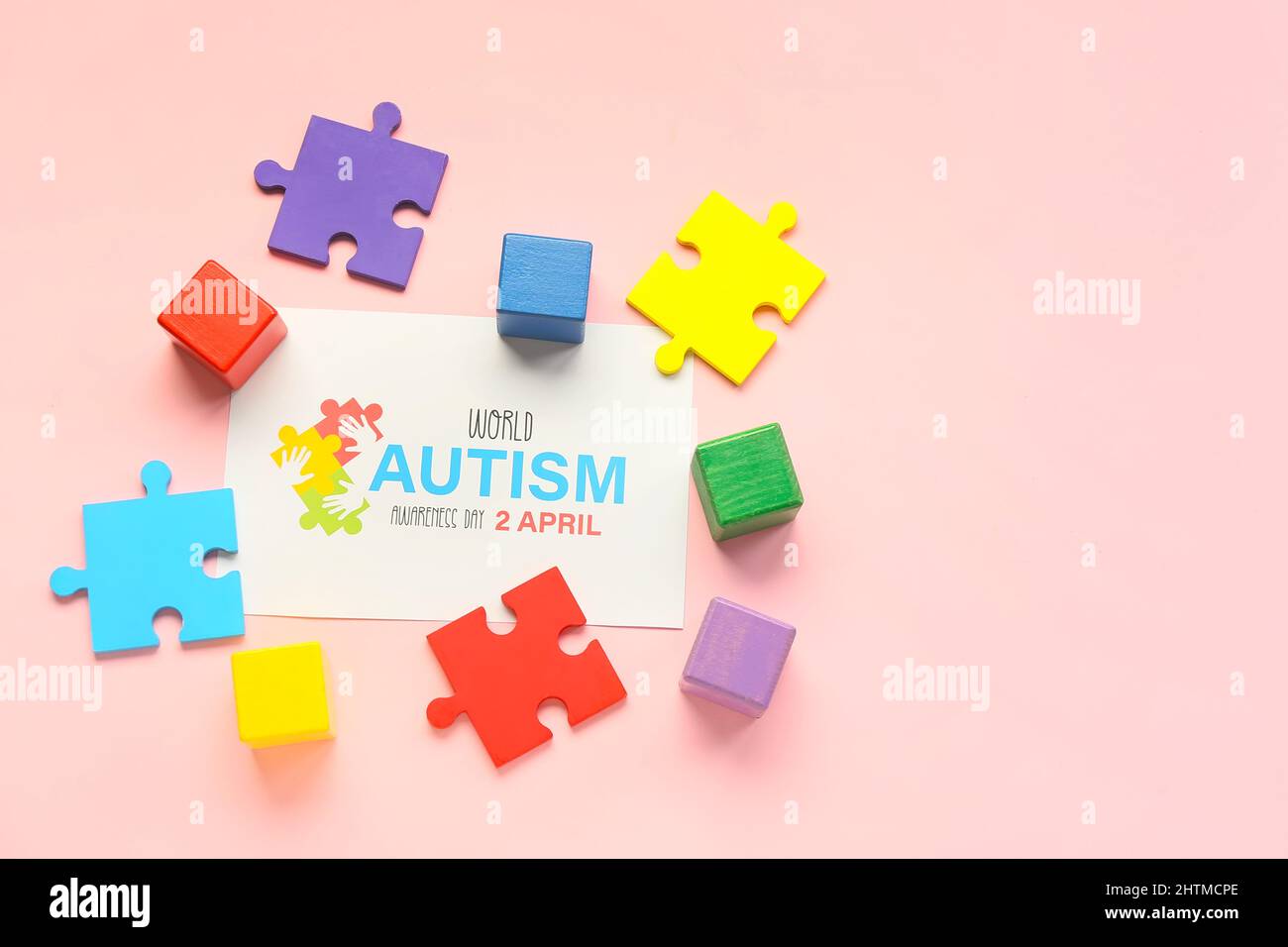 Paper sheet with text WORLD AUTISM AWARENESS DAY 2 APRIL, puzzle pieces ...