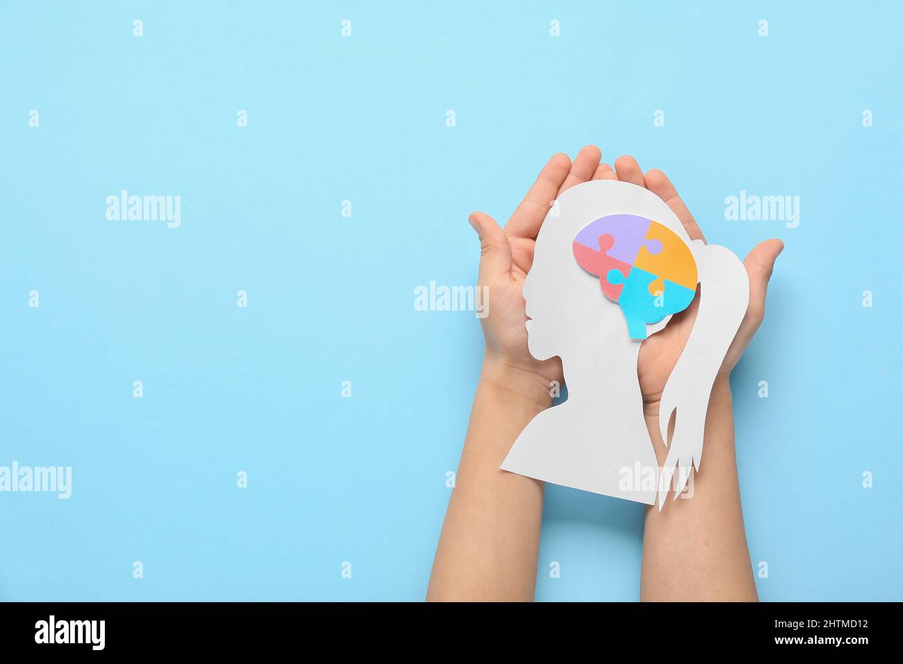 Child with paper female head on blue background. Concept of autistic ...
