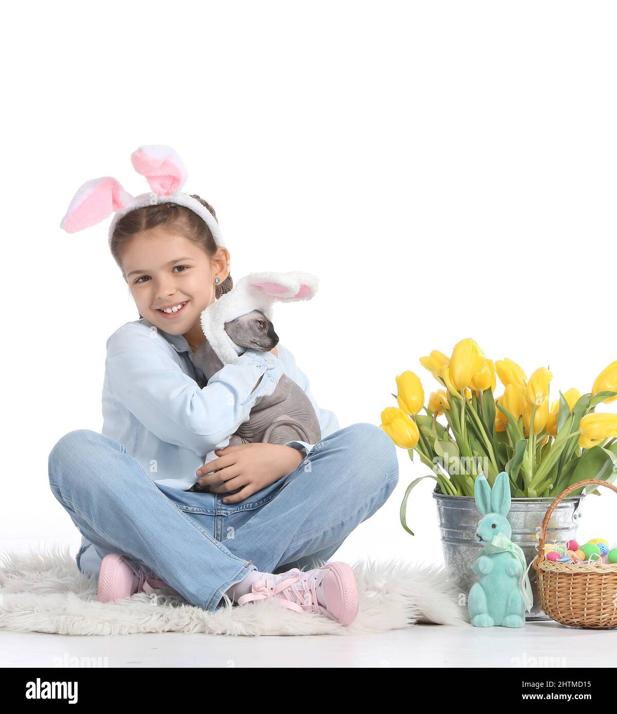Little girl with Sphynx cat, Easter eggs, rabbit and tulips on white ...