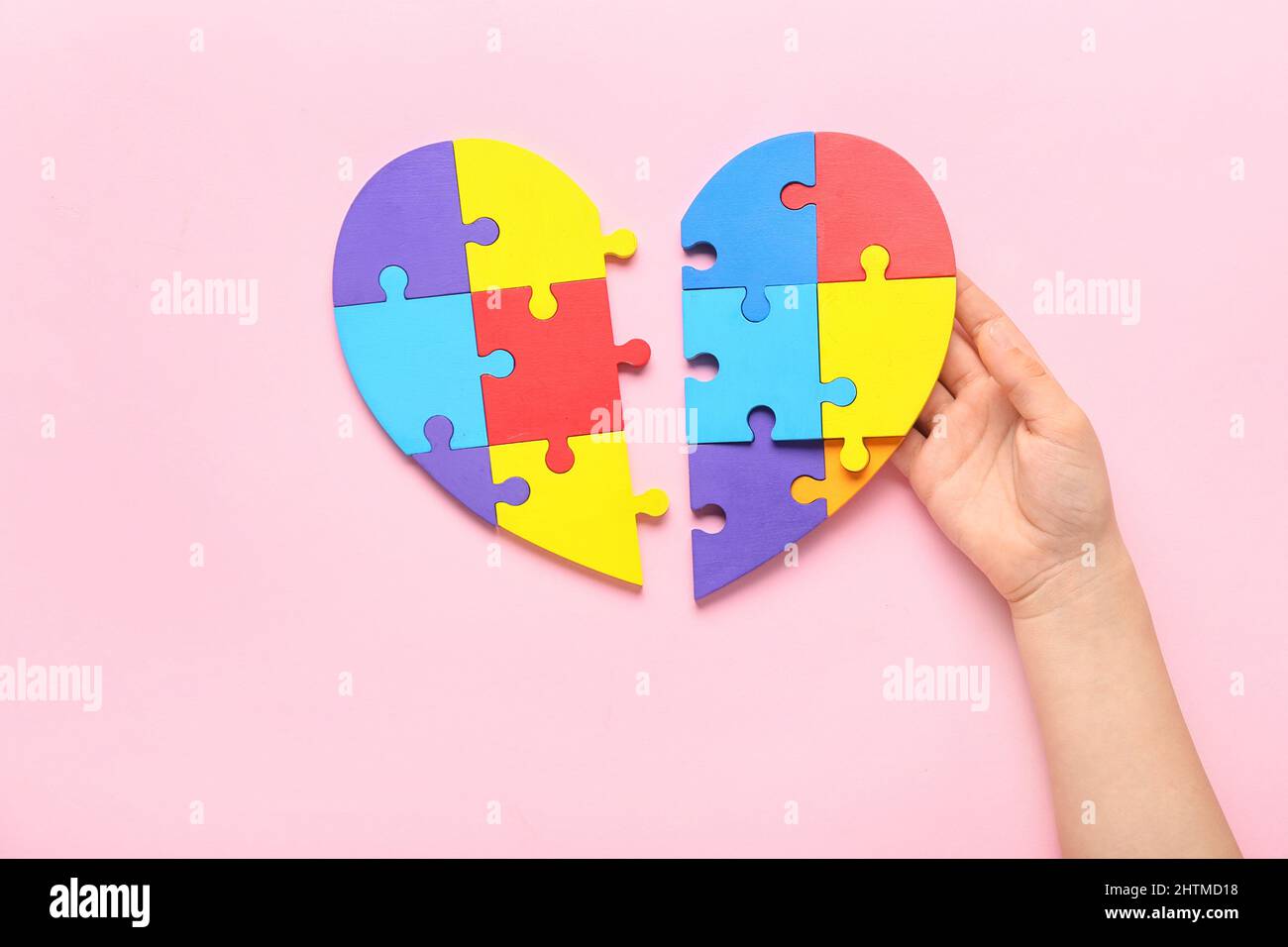 Child with puzzle pieces on pink background. Concept of autistic ...
