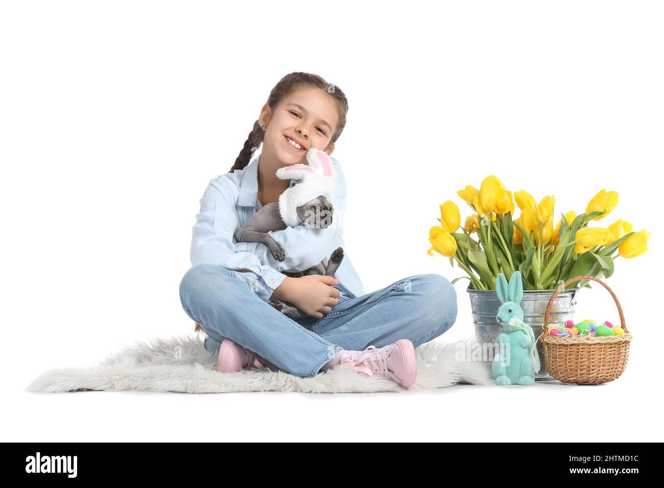 Little girl with Sphynx cat, Easter eggs, rabbit and tulips on white ...