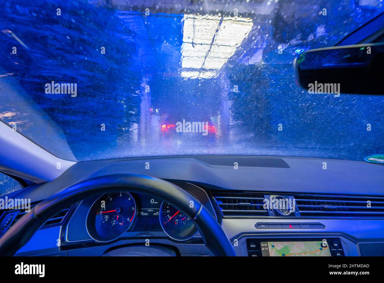 Car in an automatic car wash, car wash line, cleaning foam is sprayed ...