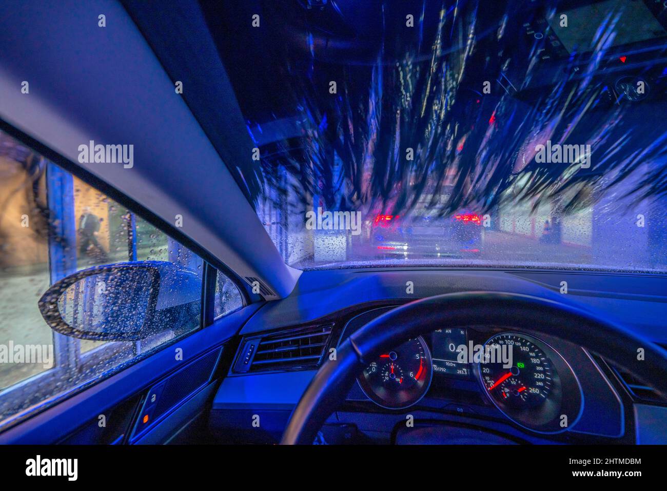 Car in an automatic car wash, car wash line, cleaning foam is sprayed ...