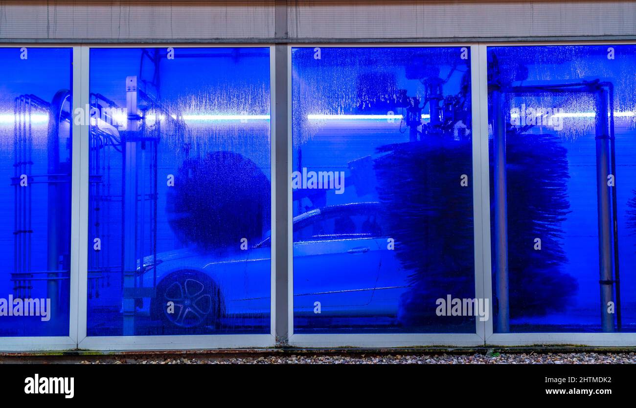 Car in an automatic car wash, car wash line, cleaning foam is sprayed ...