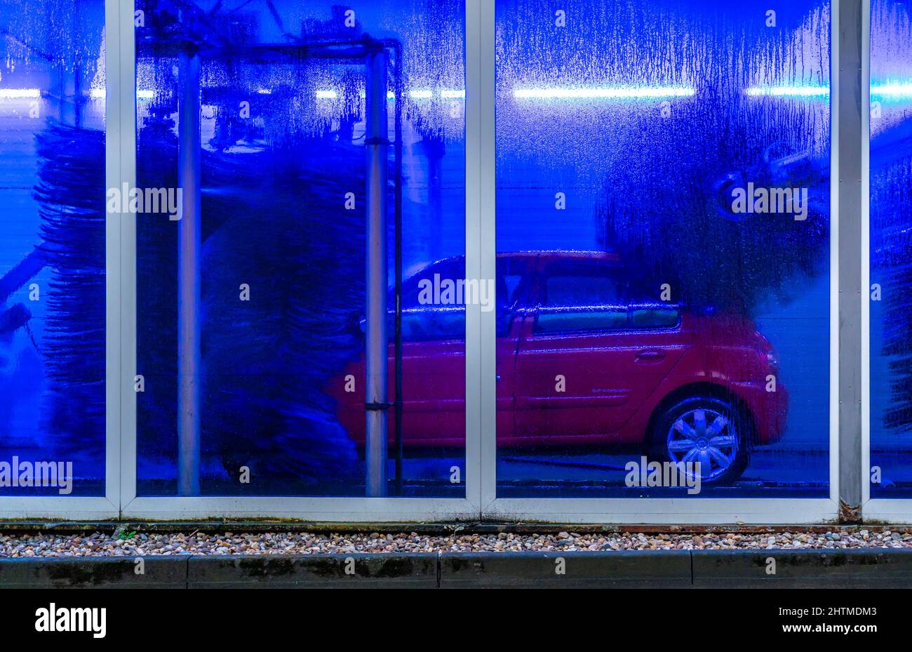 Car in an automatic car wash, car wash line, cleaning foam is sprayed ...
