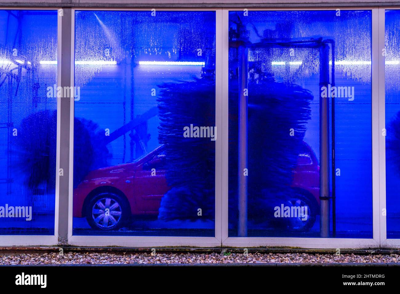 Car in an automatic car wash, car wash line, cleaning foam is sprayed ...