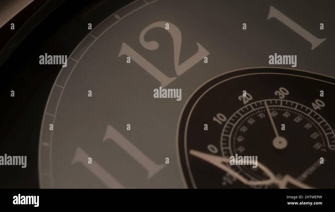Close up of clock detail with moving hand close to 12 hours, concept of ...