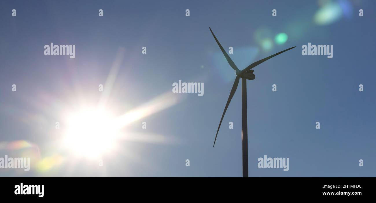 a sun ray and a wind turbine panorama Stock Photo - Alamy