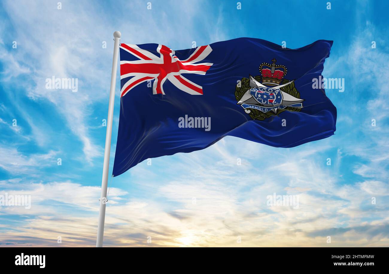 flag of Victoria Police , Australia at cloudy sky background on sunset ...
