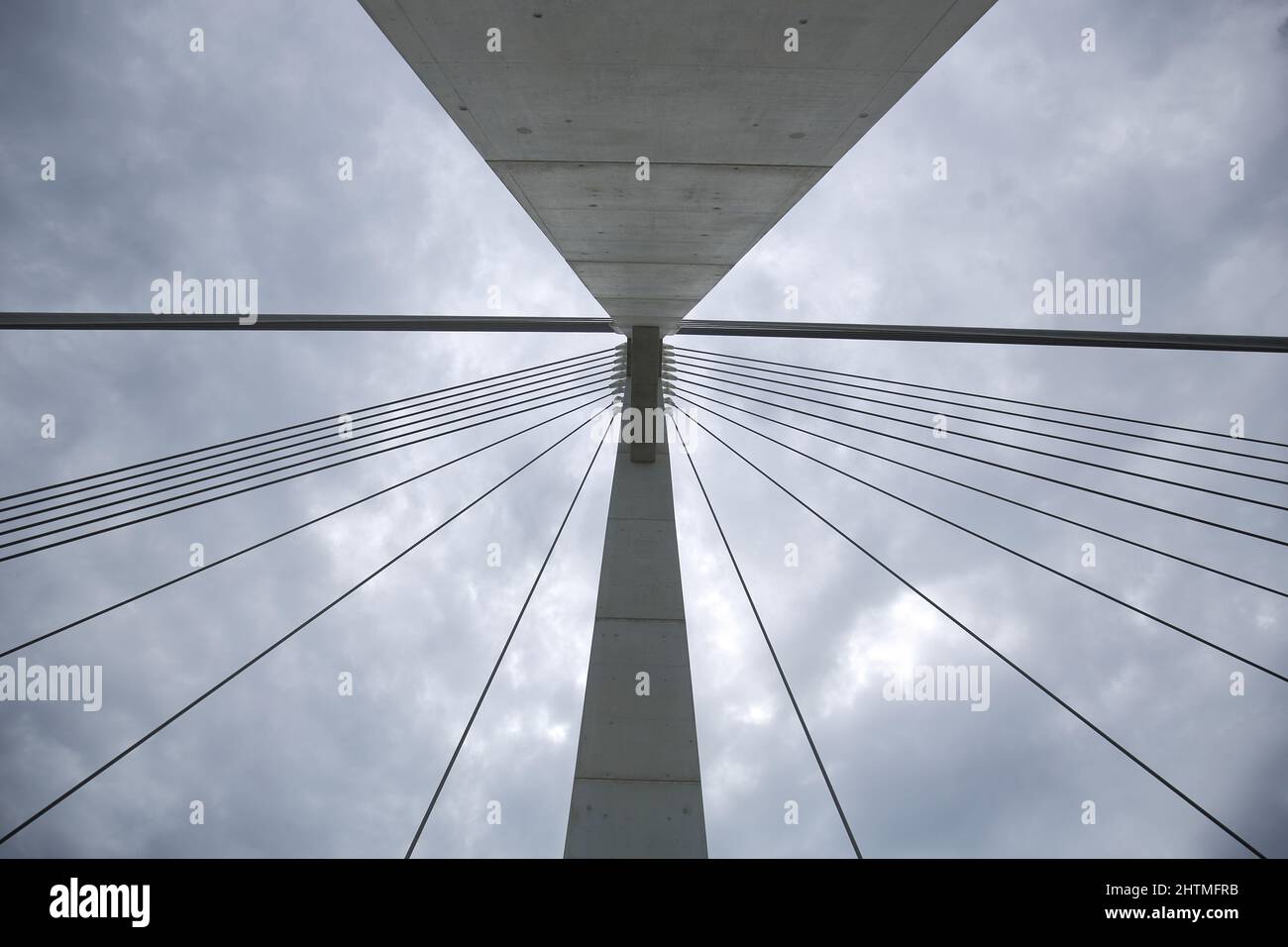 Suspension rope bridge, looking up against a gray sky, in Raunheim ...