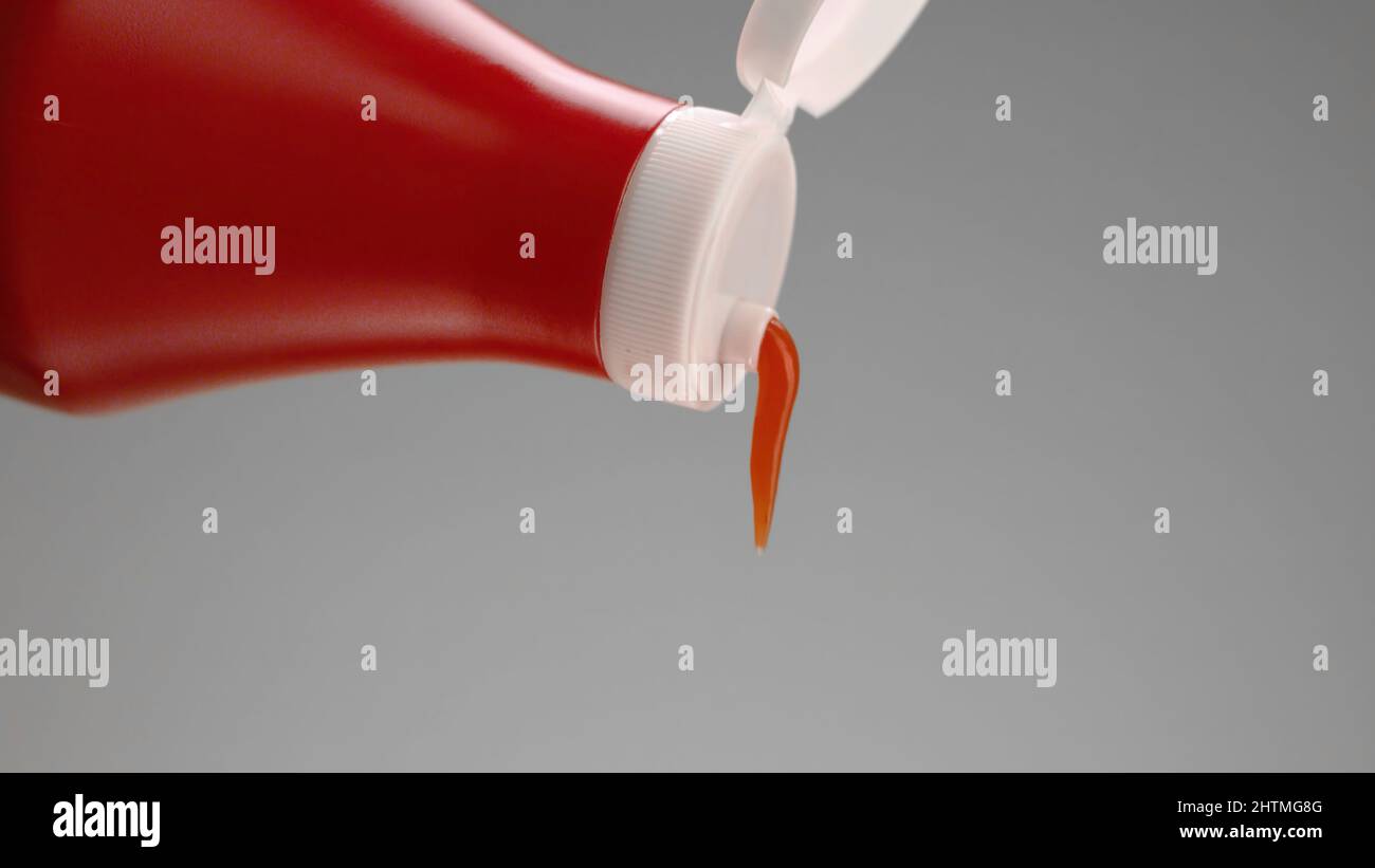 Ketchup being squeezed out of bottle. Stock footage. Close-up of jet of ...