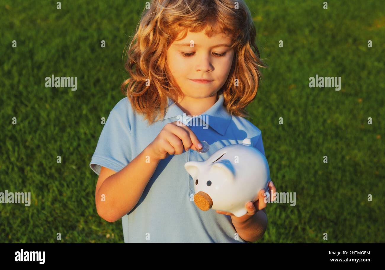 Cute boy collecting money to piggy bank. Little child boy with piggy ...