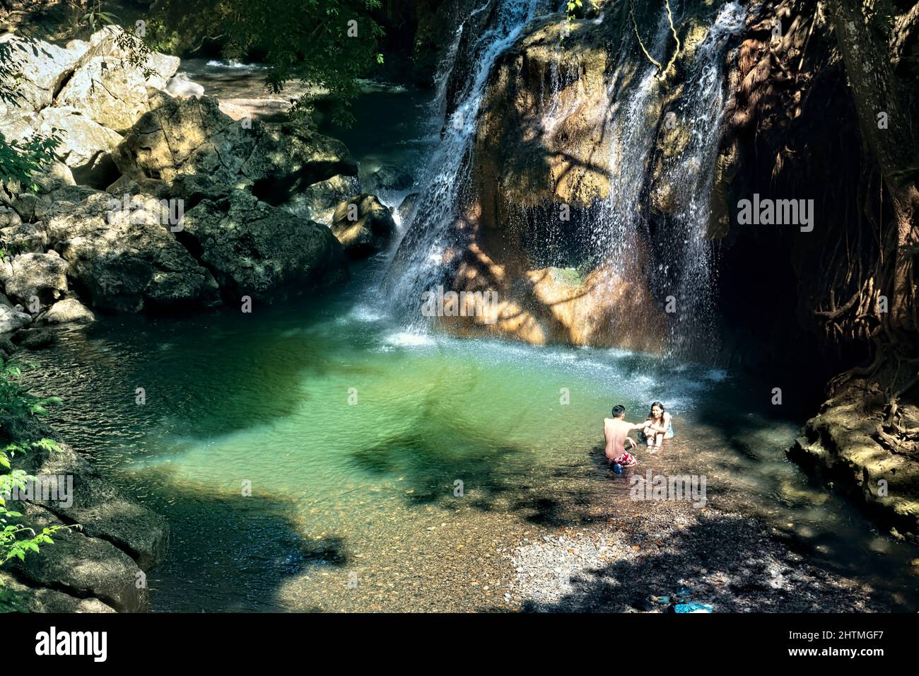 Enjoying the hot spring waterfall of Finca Paraiso, Rio Dulce ...