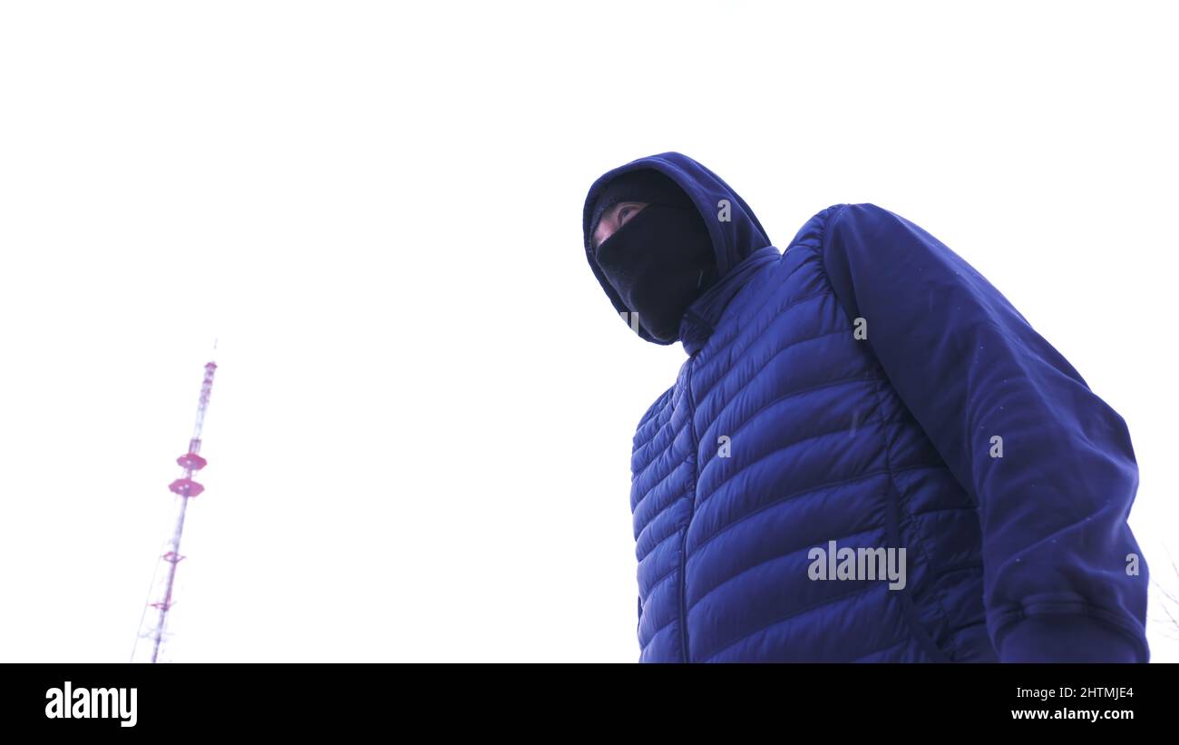 Concept of crime, thief in dark clothes on bright sky background ...