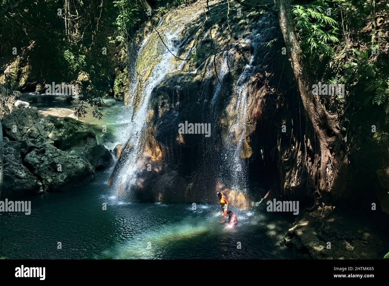 Enjoying the hot spring waterfall of Finca Paraiso, Rio Dulce ...