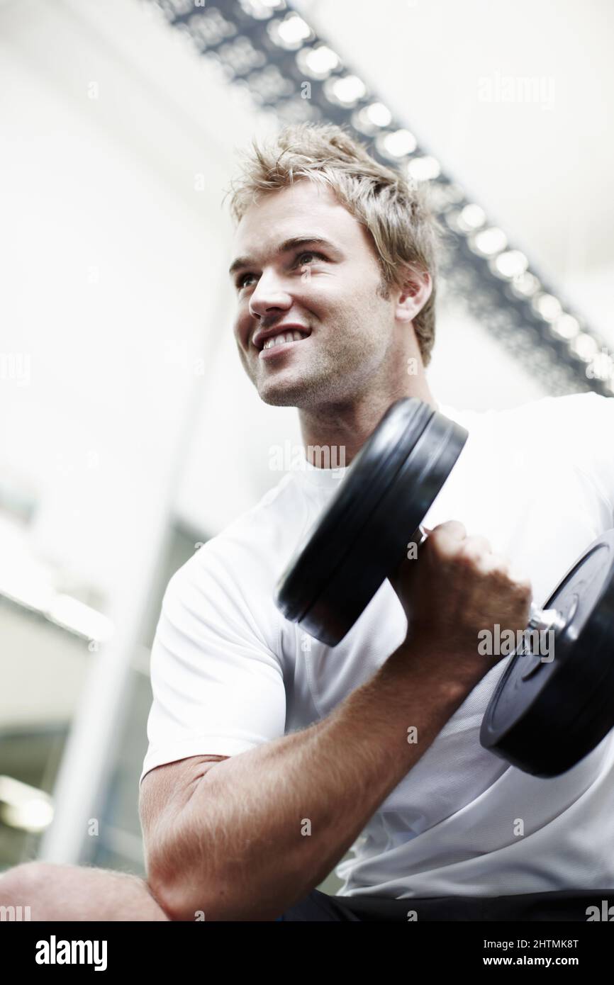 Building bulging biceps. Cropped shot of a handsome young man working ...