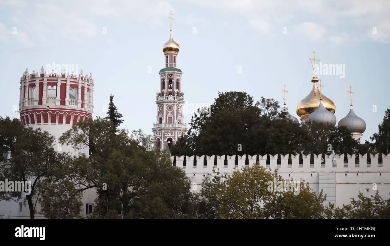 Beautiful Church buildings and towers behind wall. Action ...