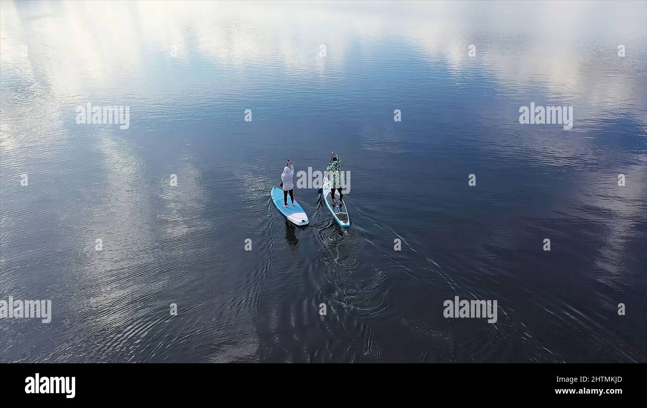 Stand-up paddleboard for SUP surfing. Footage. Top view on floating on ...