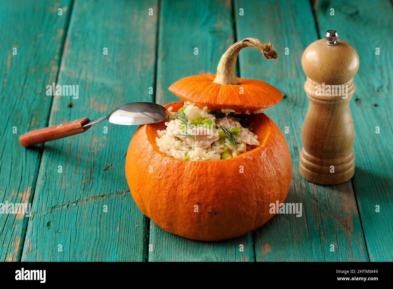 Roasted whole pumpkin with rice and meat with pepper mill horizontal ...