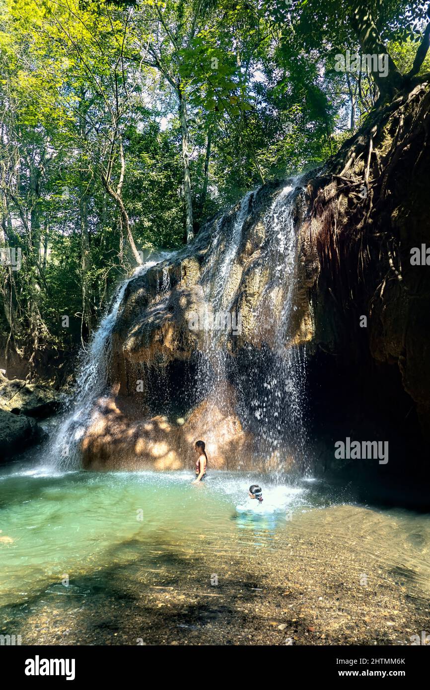Enjoying the hot spring waterfall of Finca Paraiso, Rio Dulce ...