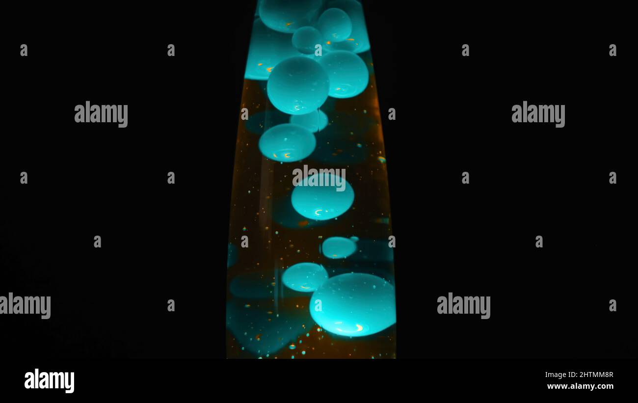 Close up view of lava lamp with blue moving bubbles. Beautiful glass ...