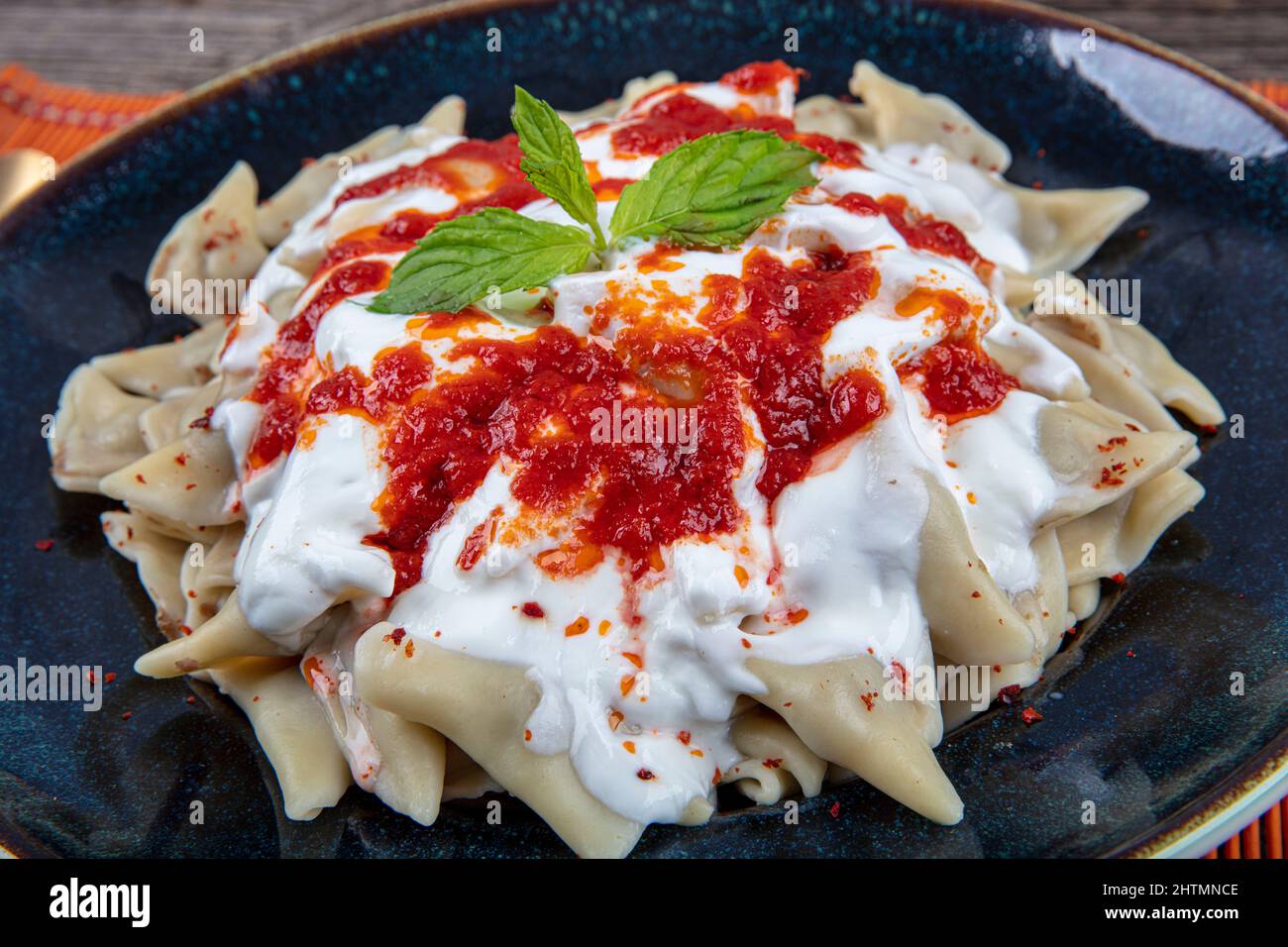 Plates of traditional Turkish food. Turkish Ravioli (Mantı) with ...