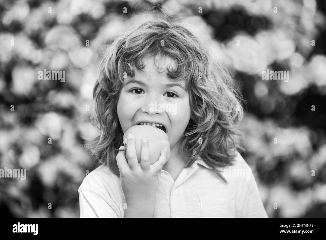 Little cute child eating green apple. Portrait of kid eating and biting ...
