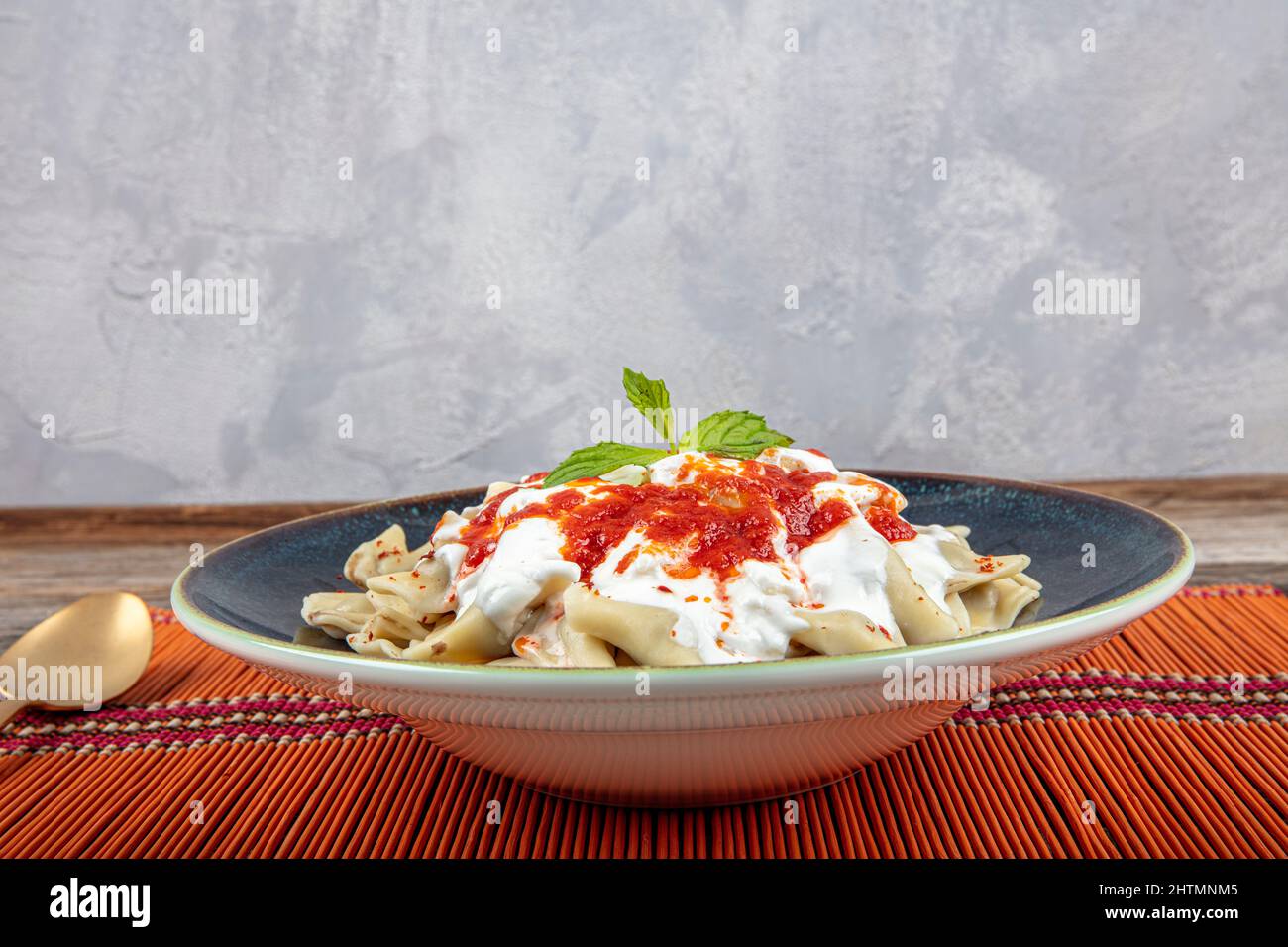 Plates of traditional Turkish food. Turkish Ravioli (Mantı) with ...