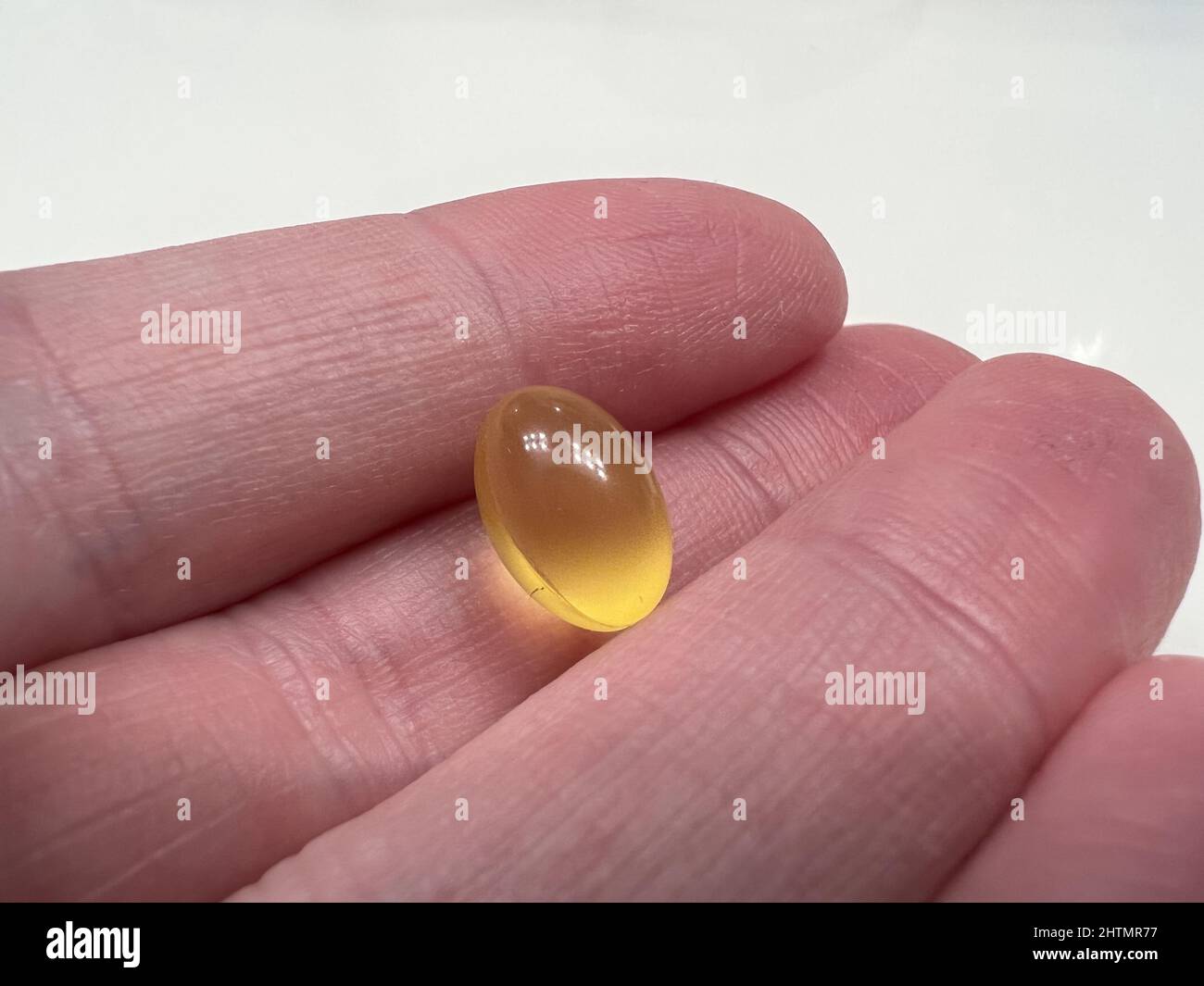 Person's hand holding a small Vitamin D pill or supplement, Lafayette ...