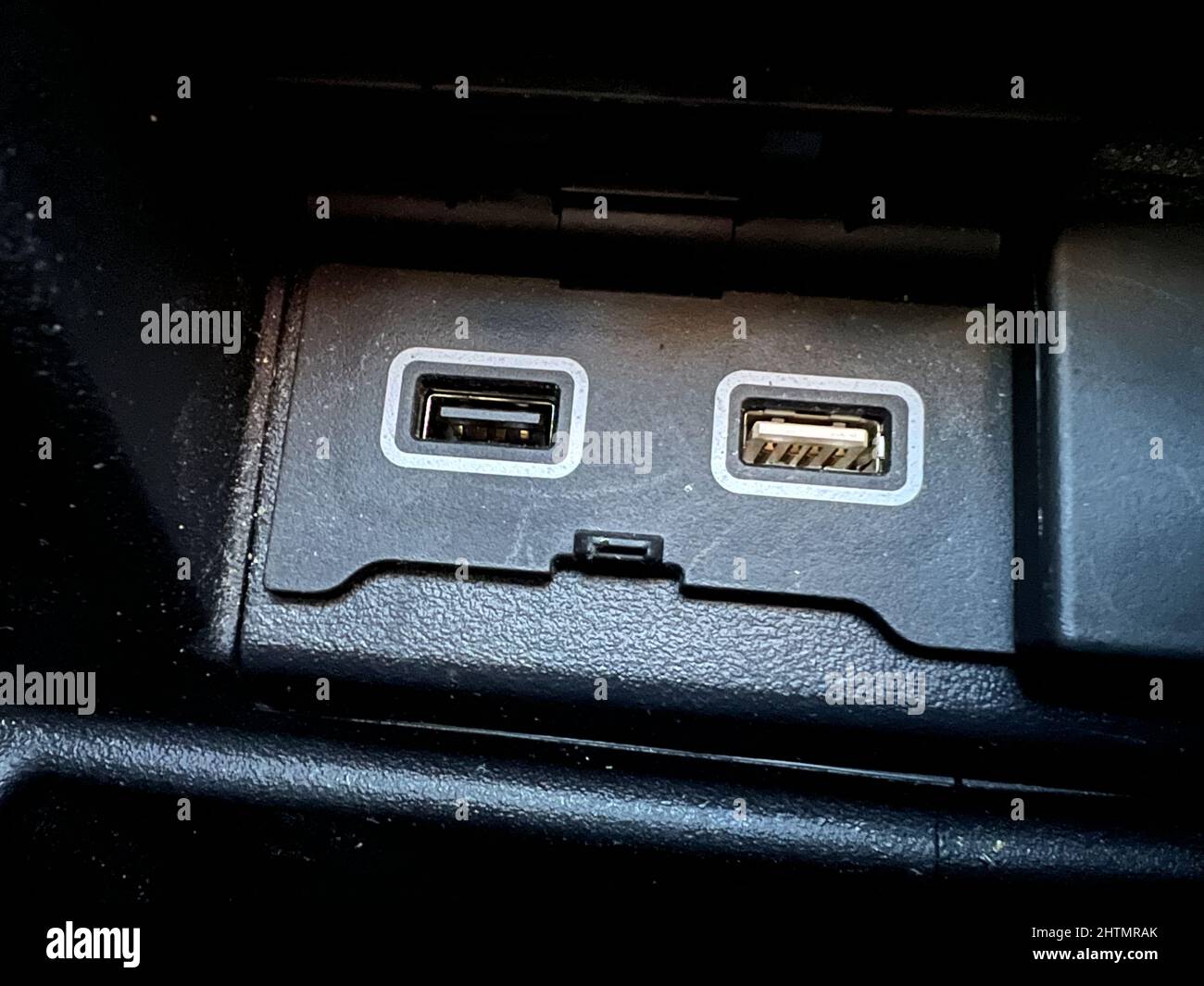 Two auxiliary USB ports for phone charging and connection are visible ...