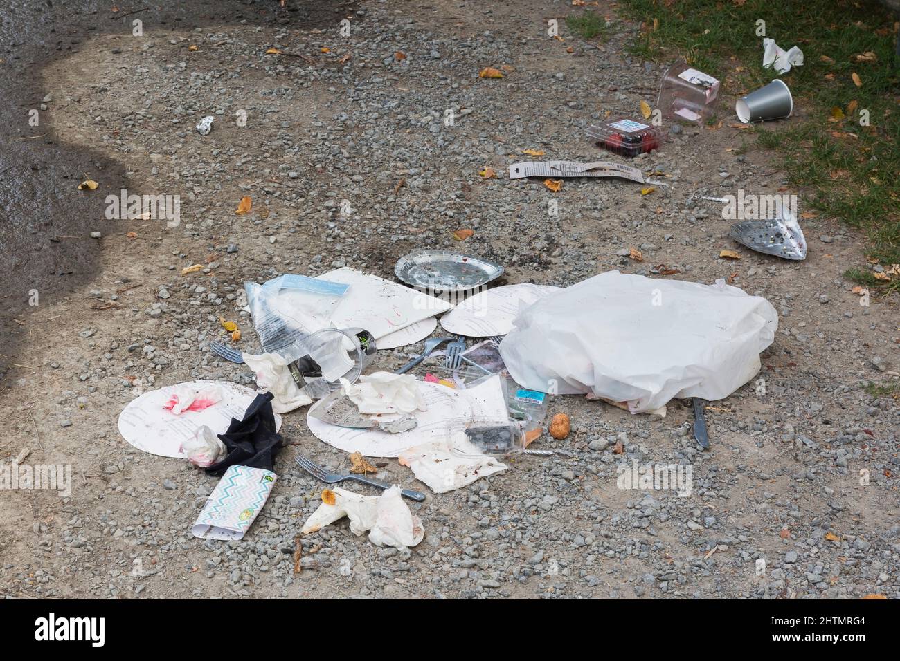 Recyclable garbage discarded on gravel path in public park Stock Photo ...