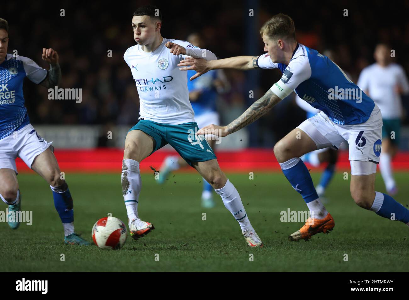 Peterborough, UK. 01st Mar, 2022. Phil Foden (MC) evades Frankie Kent ...