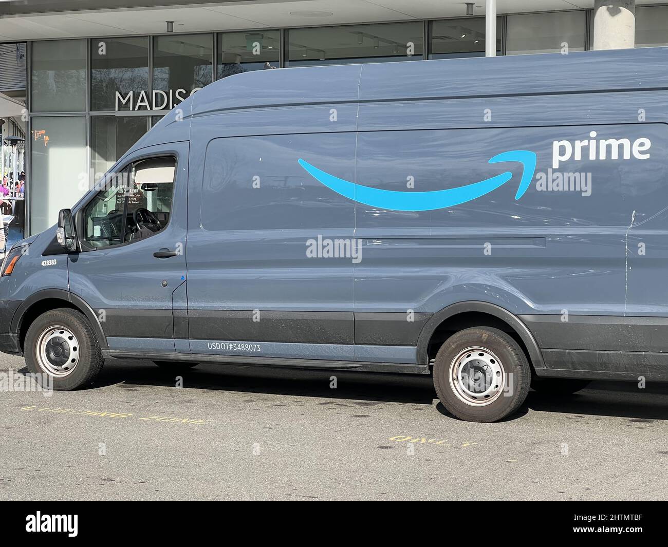 An Amazon Prime delivery truck is parked beside a shopping center in ...