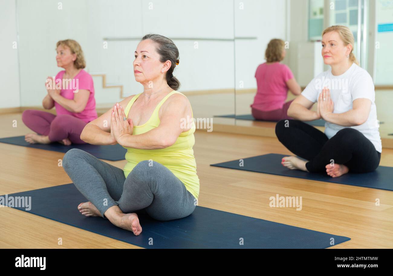 Woman making yoga meditation in half king of fish yoga pose - agni ...