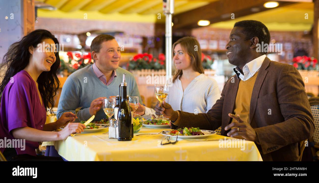 Happy adult people having fun in restaurant during dinner Stock Photo ...