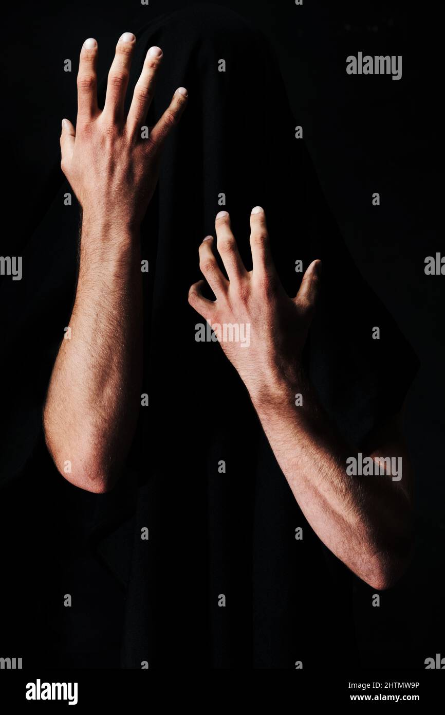Magic trick. Two arms isolated against a black background Stock Photo ...