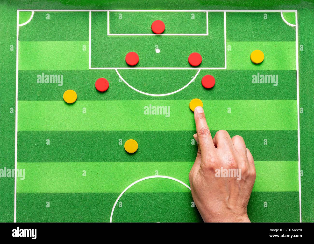 Close-up on a coach showing football players the line up on the field ...