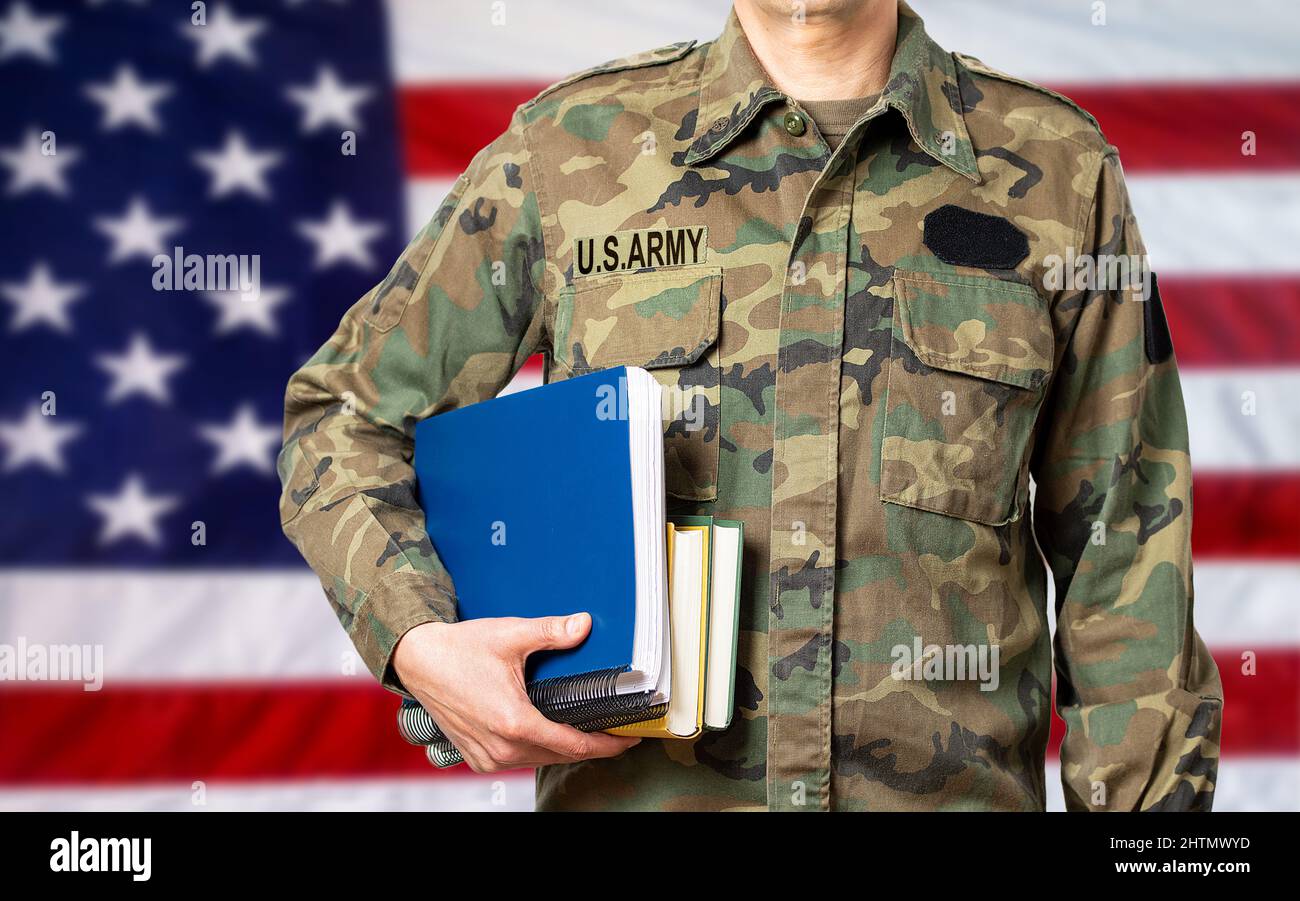 Soldier with books in hand and ready to go back to school as a student ...