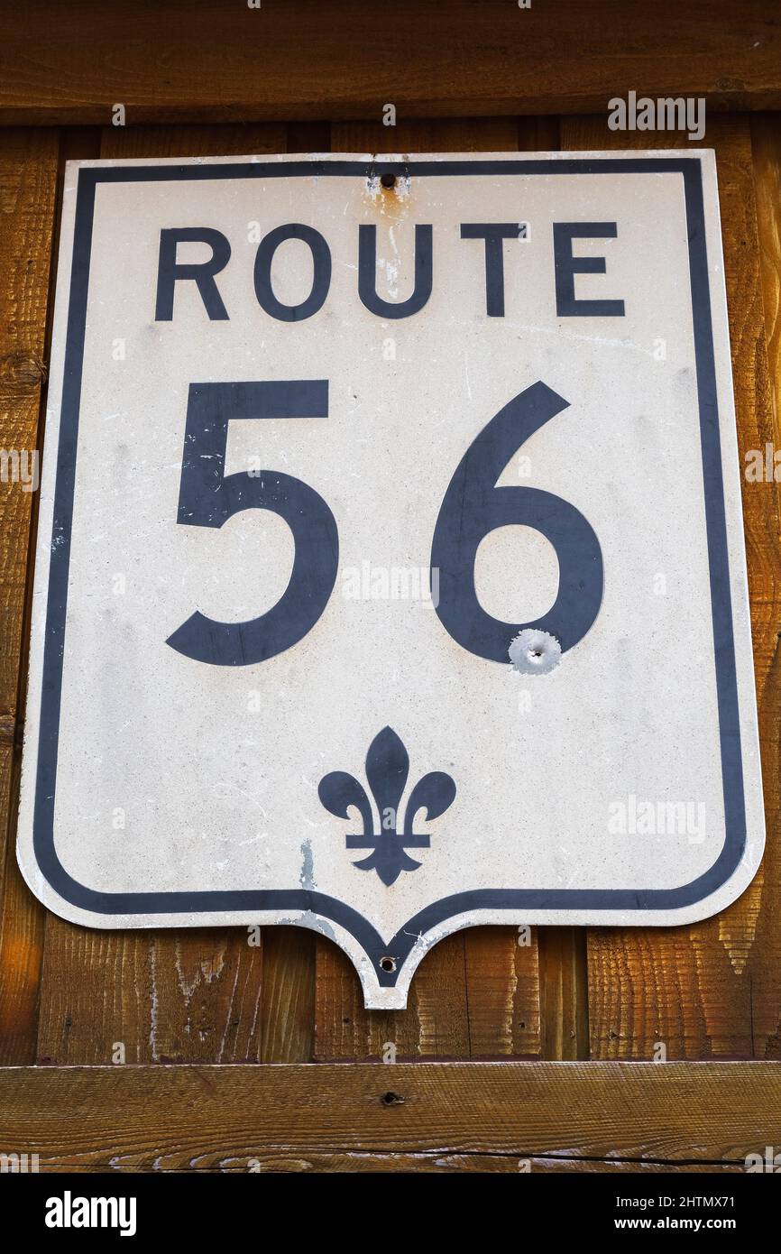 Old Quebec Provincial Route 56 highway metal sign on rustic wood plank ...