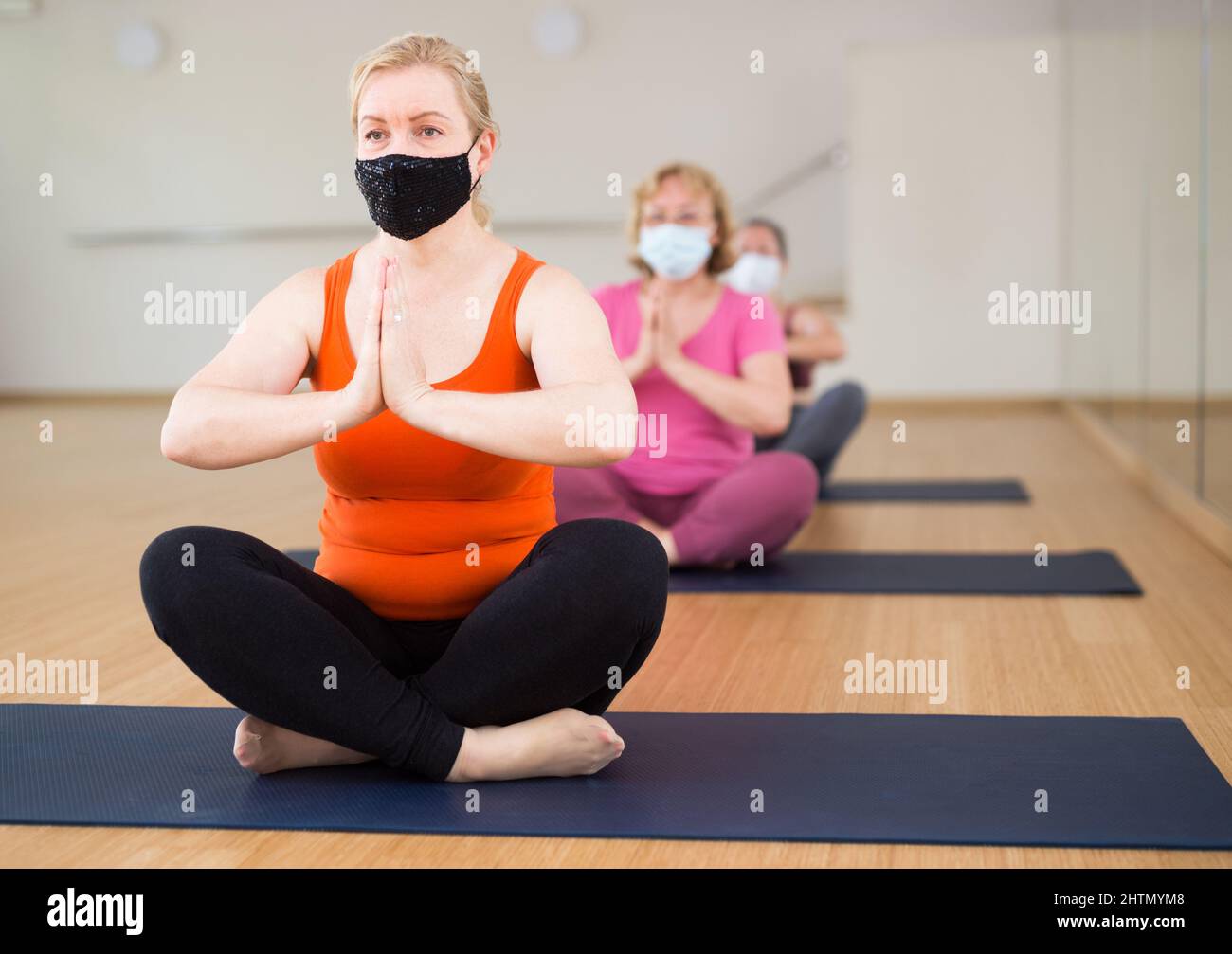 Ladies in masks are sitting in a lotus pose Stock Photo - Alamy